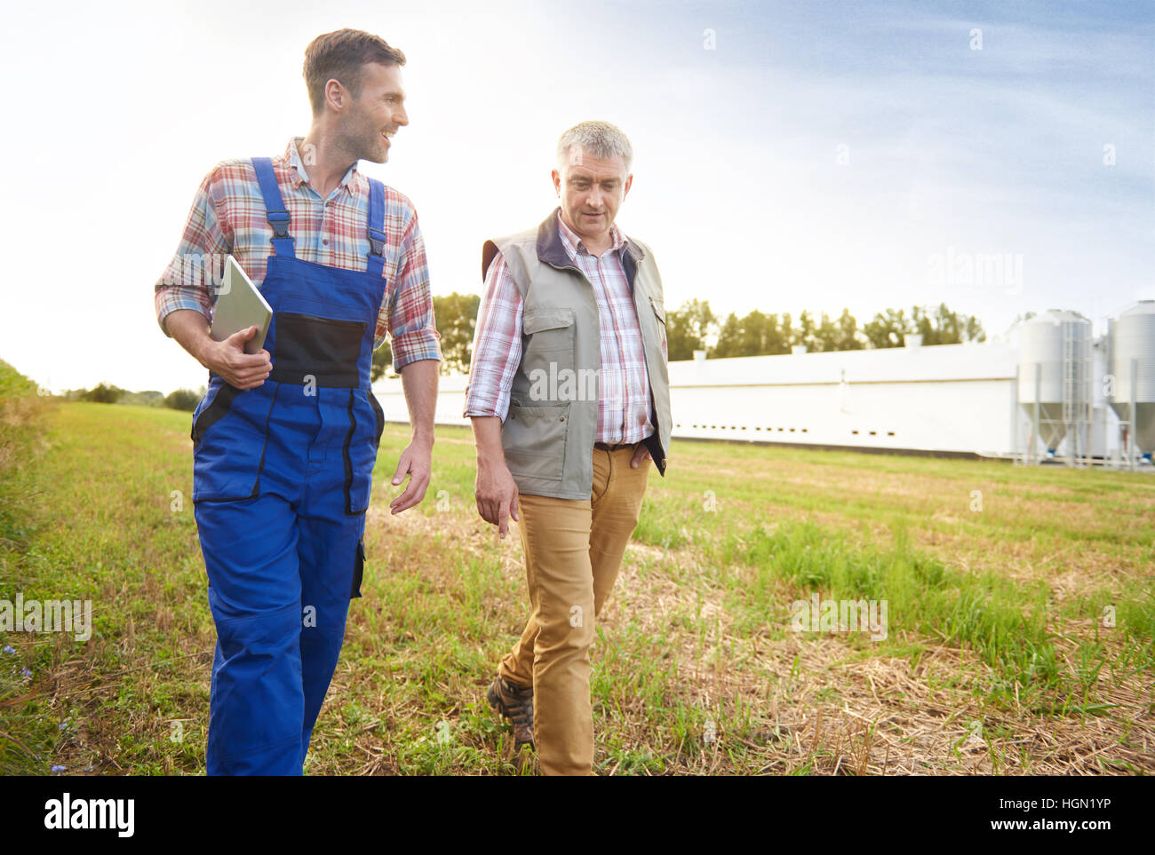 Modern farmers on the field Stock Photo - Alamy