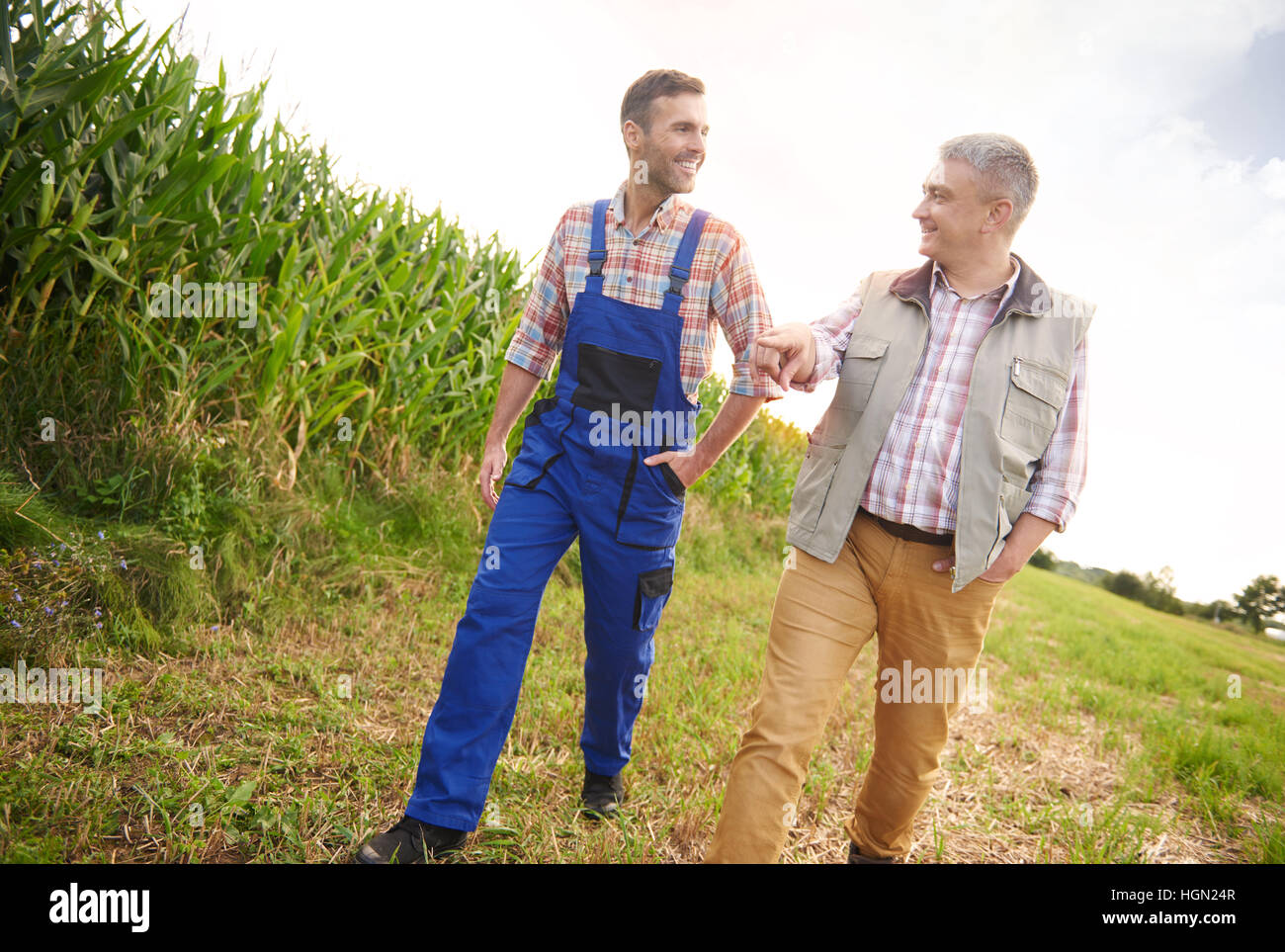 Two farmers on the field Stock Photo - Alamy