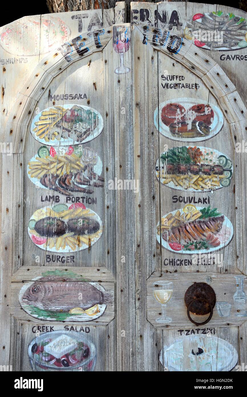 Greek and international menus painted onto a wooden door outside a ...