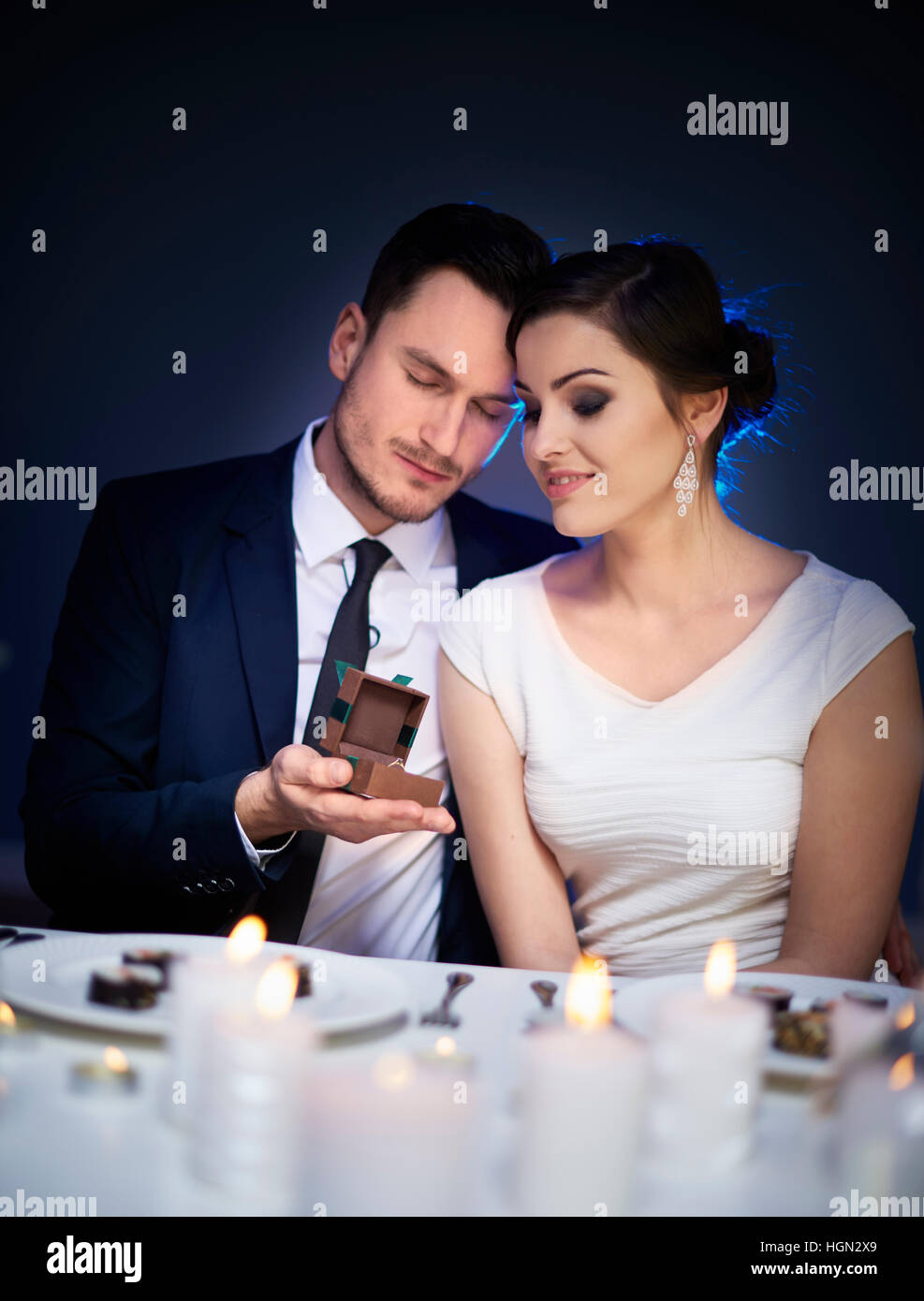 Man surprising woman with engagement ring at restaurant table Stock ...