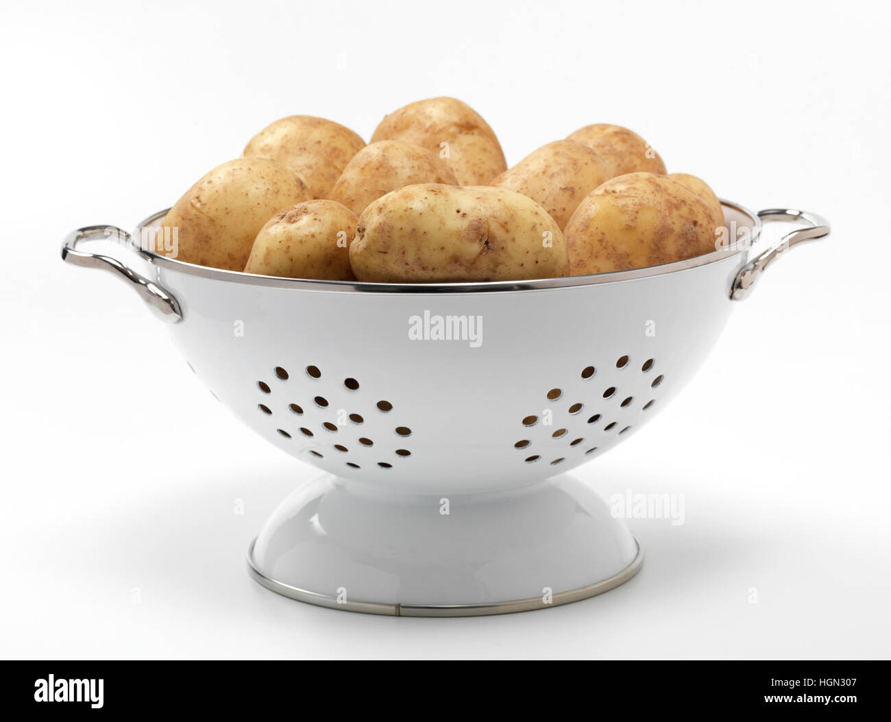 Potato in colander on white Stock Photo - Alamy