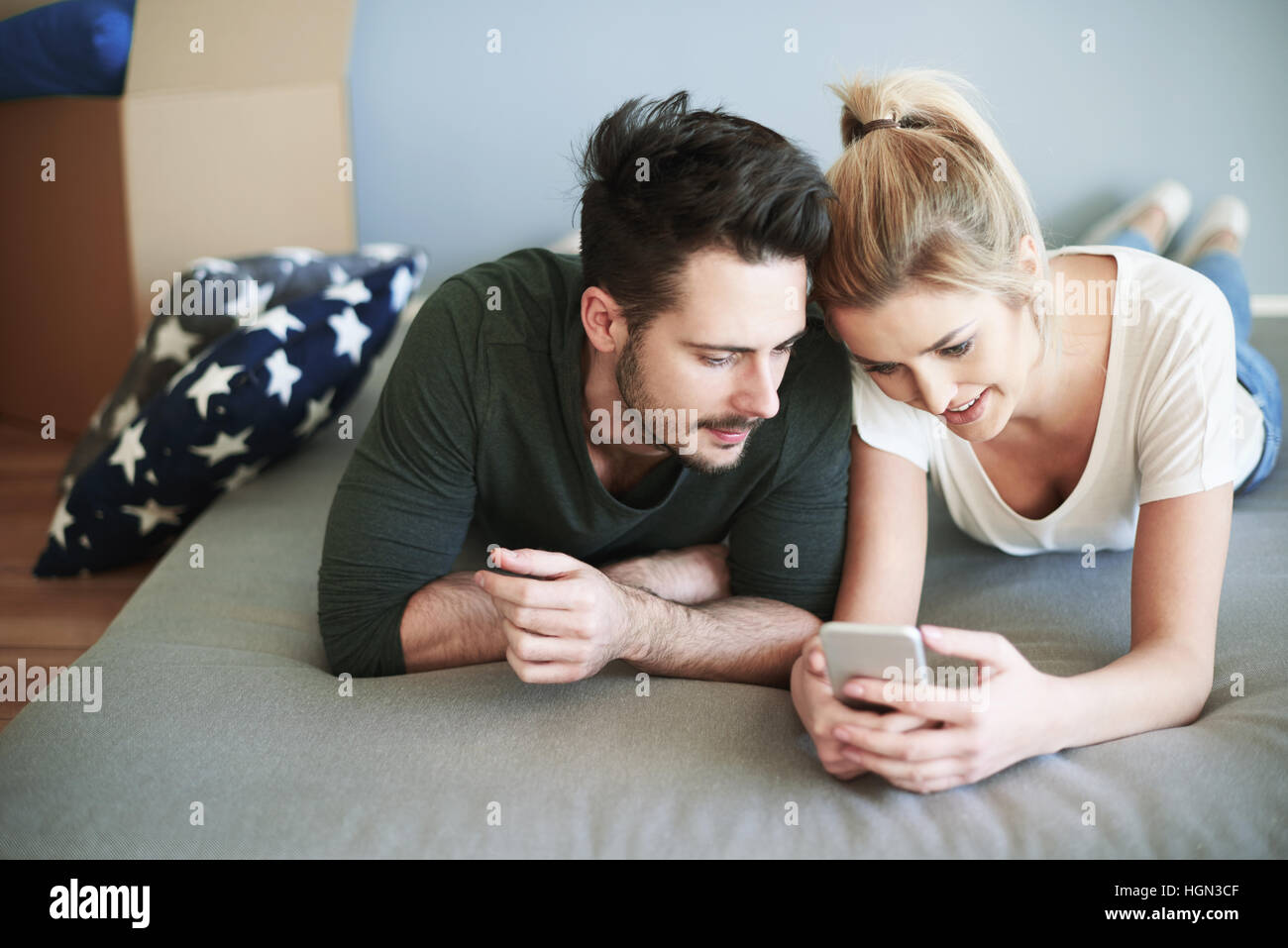Young couple together surfing the net Stock Photo - Alamy