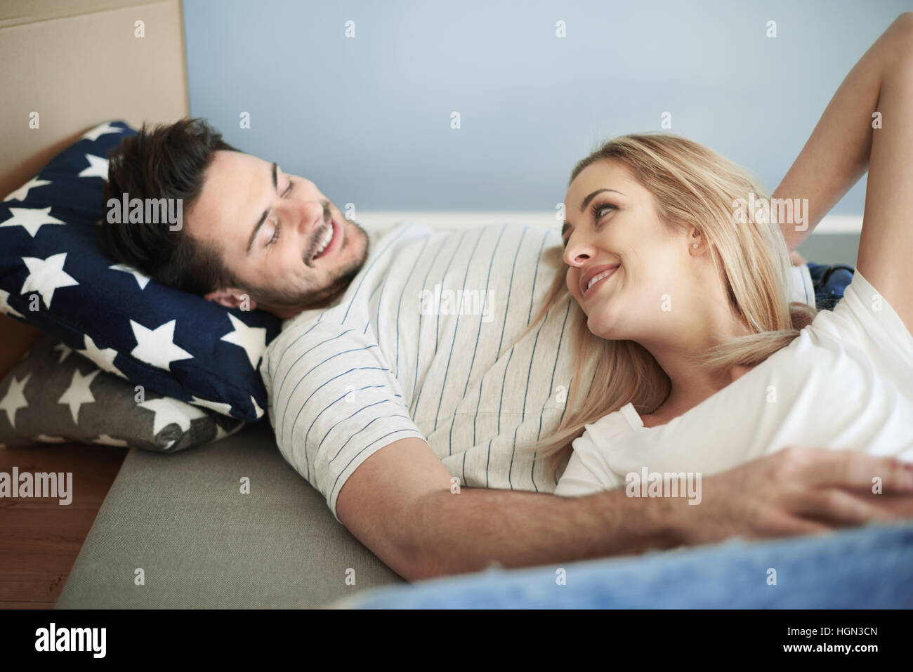 Couple lying down on the mattress Stock Photo - Alamy
