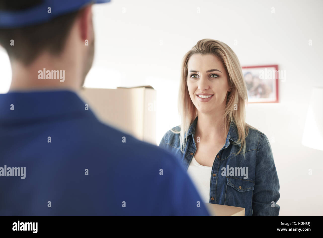 Expressing delight at receiving her express delivery Stock Photo - Alamy