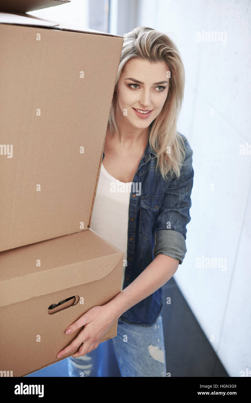 Woman carrying cardboard boxes at her new home Stock Photo - Alamy