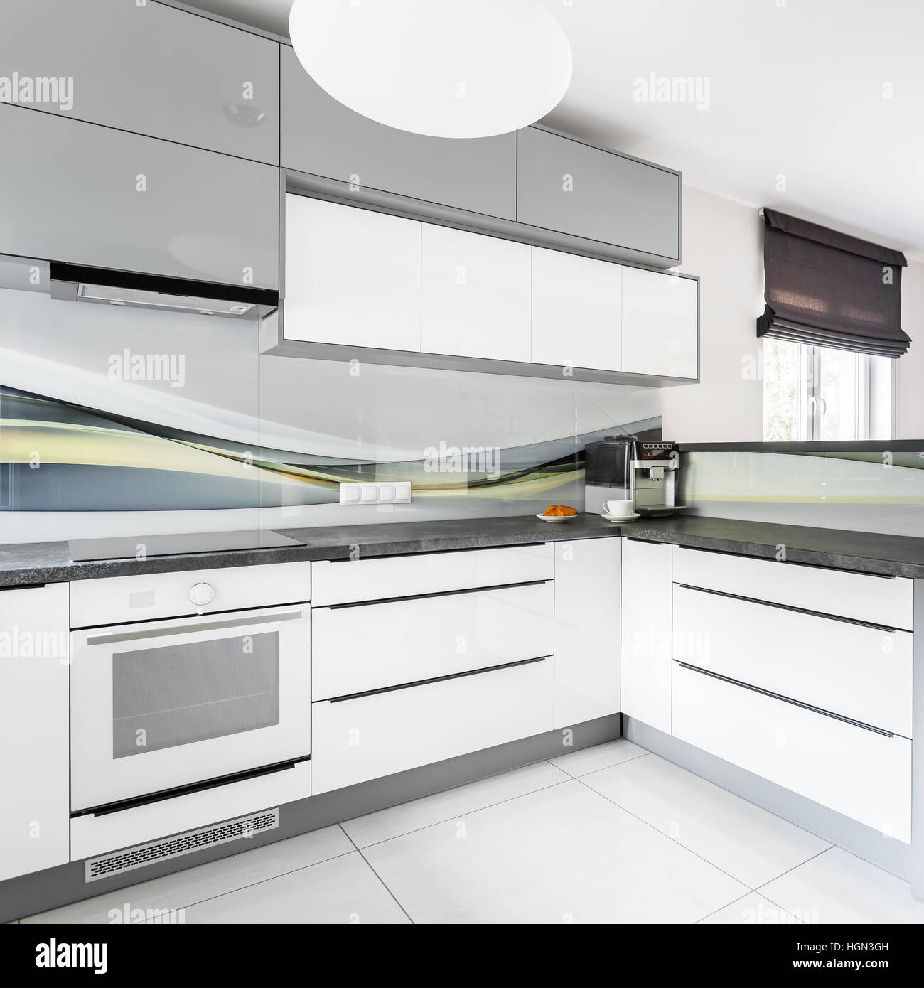 New functional kitchen with white and grey furniture Stock Photo - Alamy