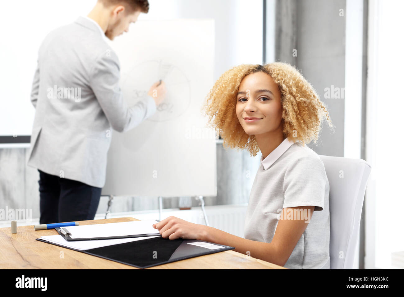 Young woman during training business sitting at a conference table ...