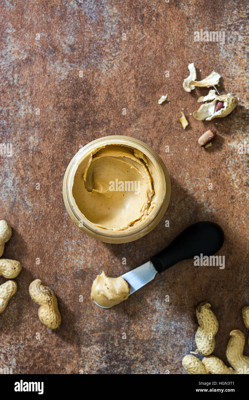 Creamy peanut butter and knife on rusty background Stock Photo - Alamy