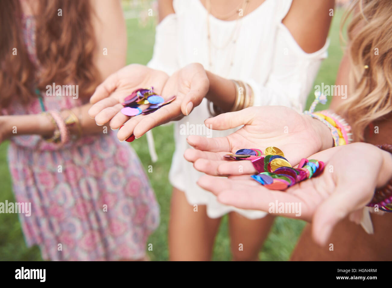 Lots of confetti on girls hands Stock Photo - Alamy