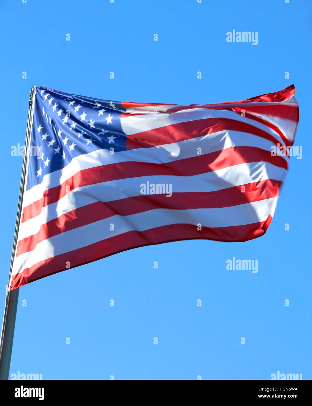 fantastic large American flag waving high in the blue sky Stock Photo ...