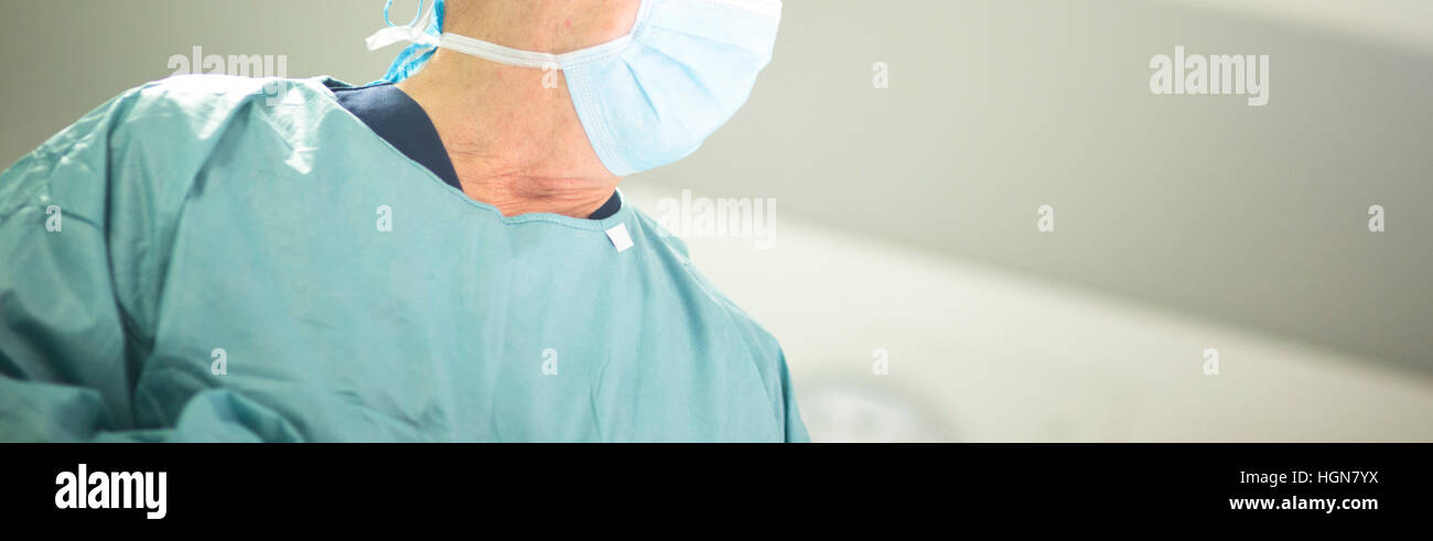 Surgeon in hospital surgery in sterile uniform "scrubs" and mask in ...