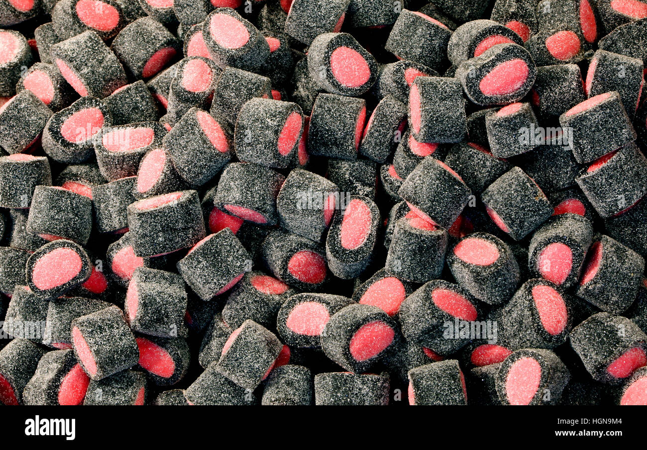 small pieces of licorice filled with pink sugar Stock Photo - Alamy