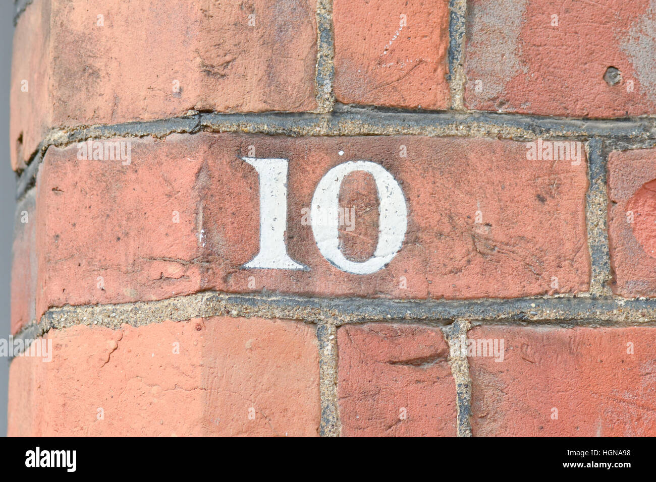 House Number 10 sign painted white on red brick wall Stock Photo - Alamy