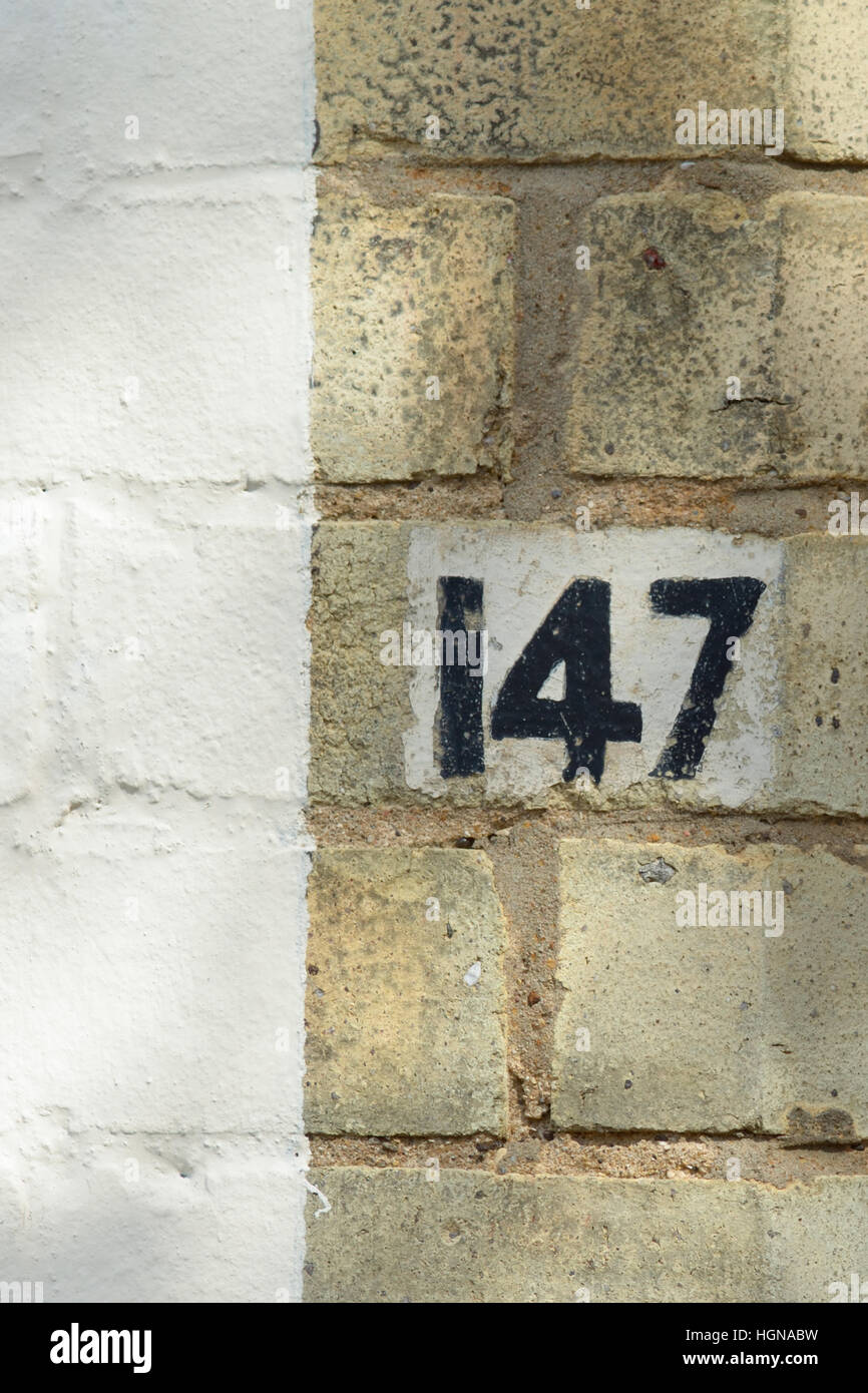 House Number 147 painted sign on wall Stock Photo - Alamy
