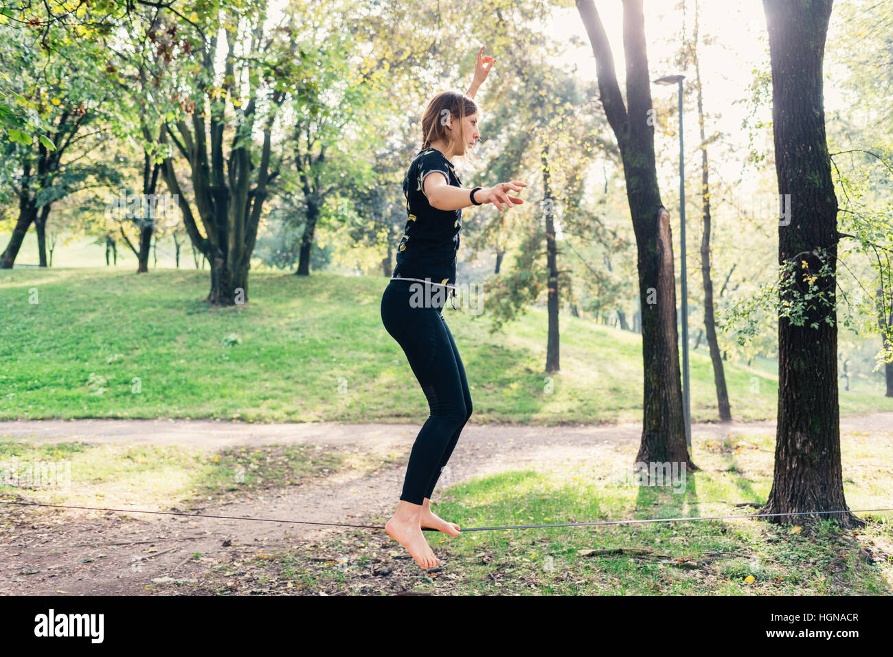 Woman training slackline in hi-res stock photography and images - Alamy