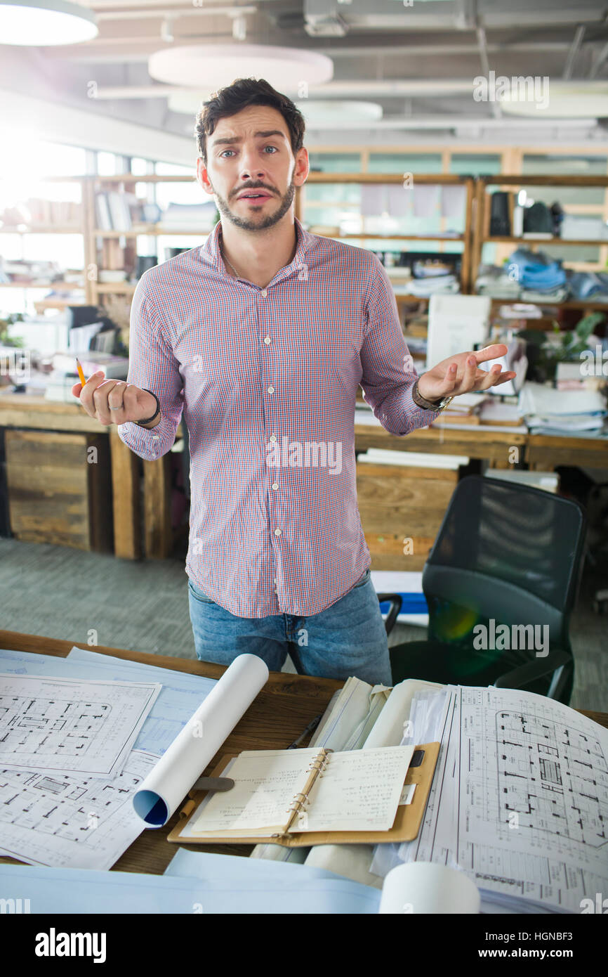 Confused male architect Stock Photo - Alamy