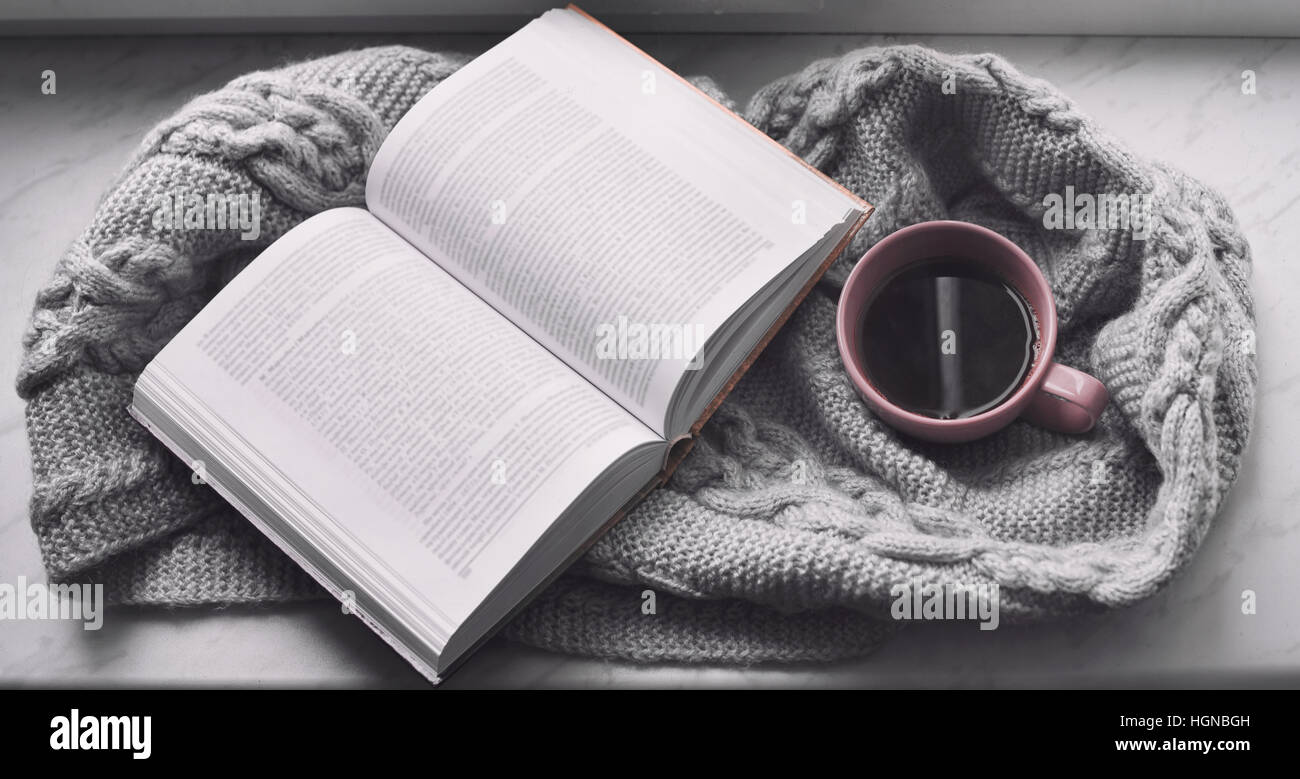 Cozy home still life: cup of hot coffee and opened book with warm plaid ...