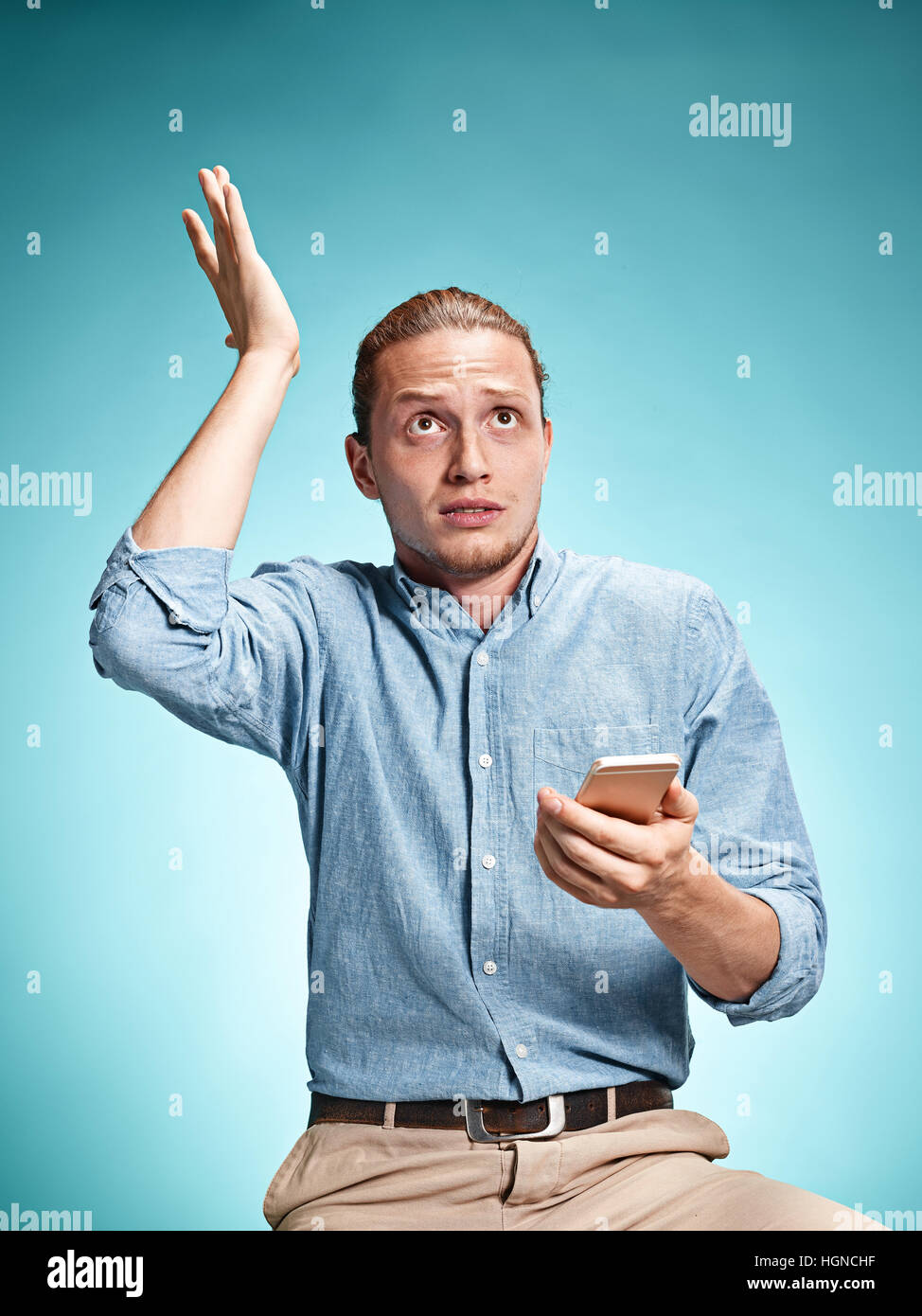The young surprised caucasian man on blue background Stock Photo - Alamy