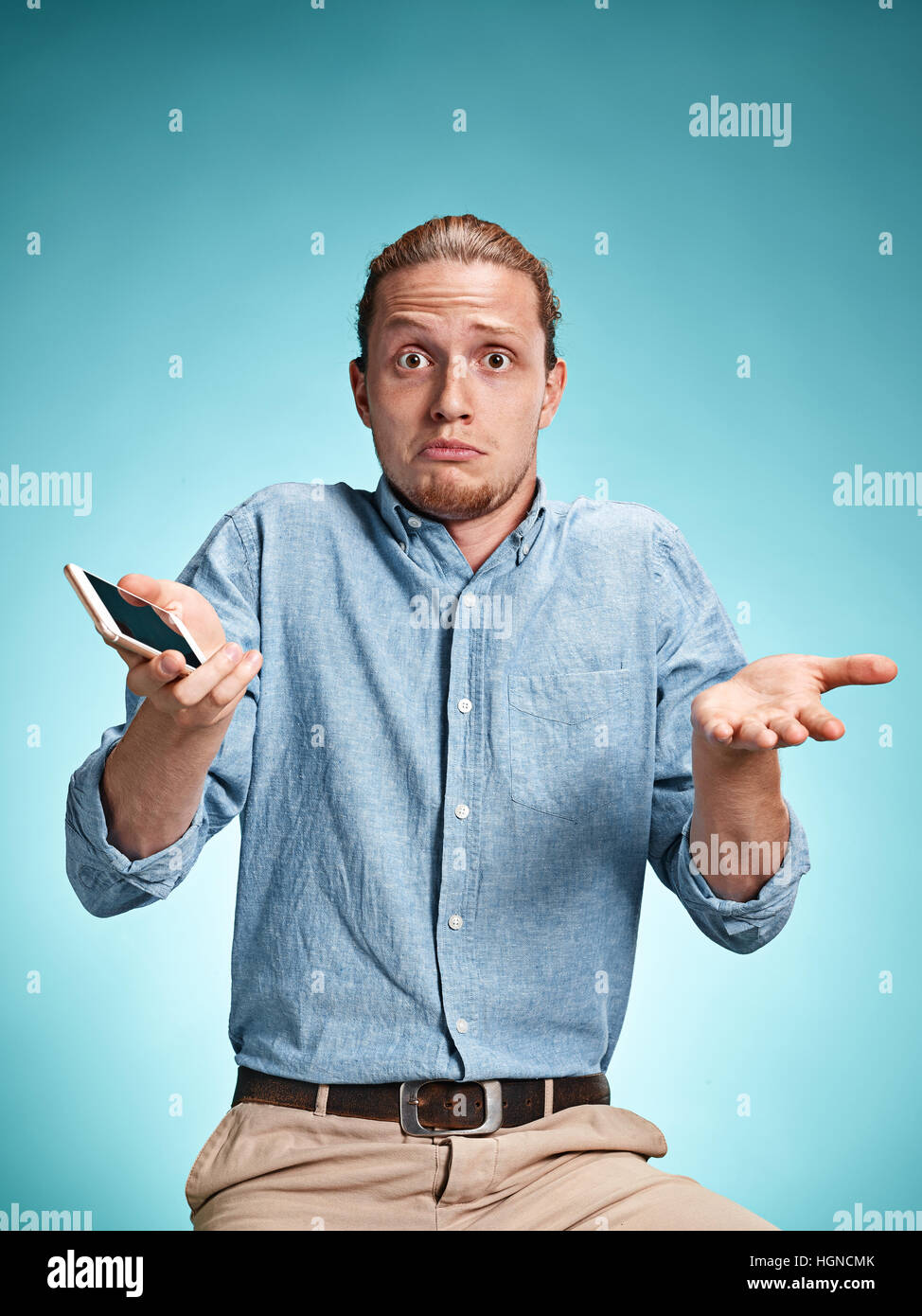 The young surprised caucasian man on blue background Stock Photo - Alamy