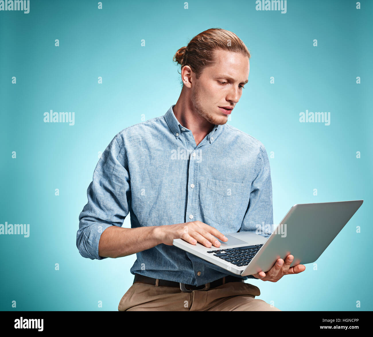 Sad Young Man Working On Laptop Stock Photo - Alamy