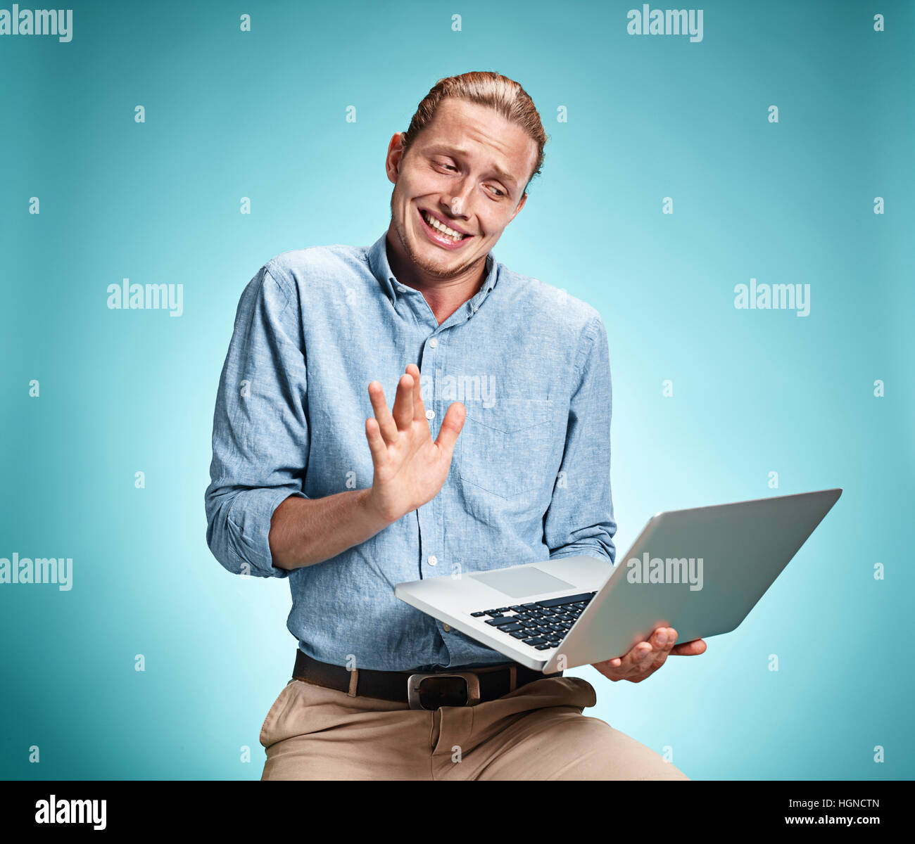 Sad Young Man Working On Laptop Stock Photo - Alamy