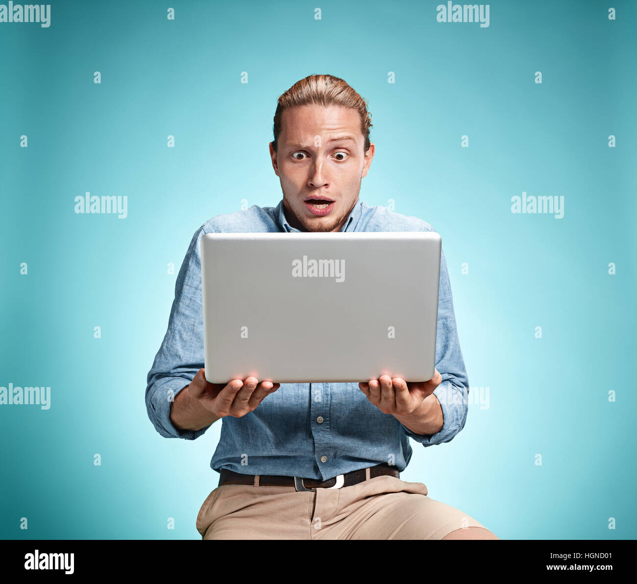 Sad Young Man Working On Laptop Stock Photo - Alamy