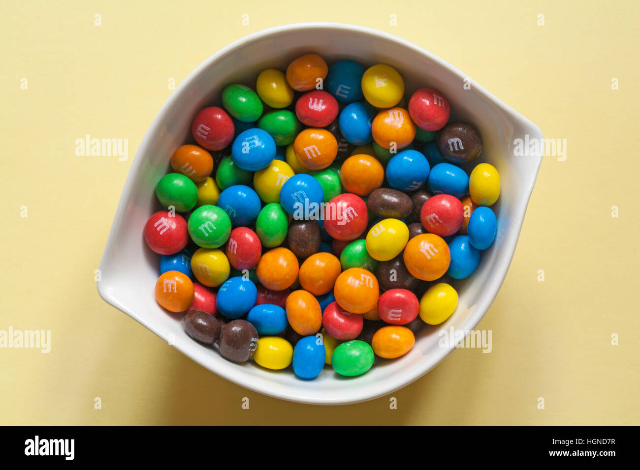 crispy M&Ms in bowl isolated on pale yellow coloured background Stock ...