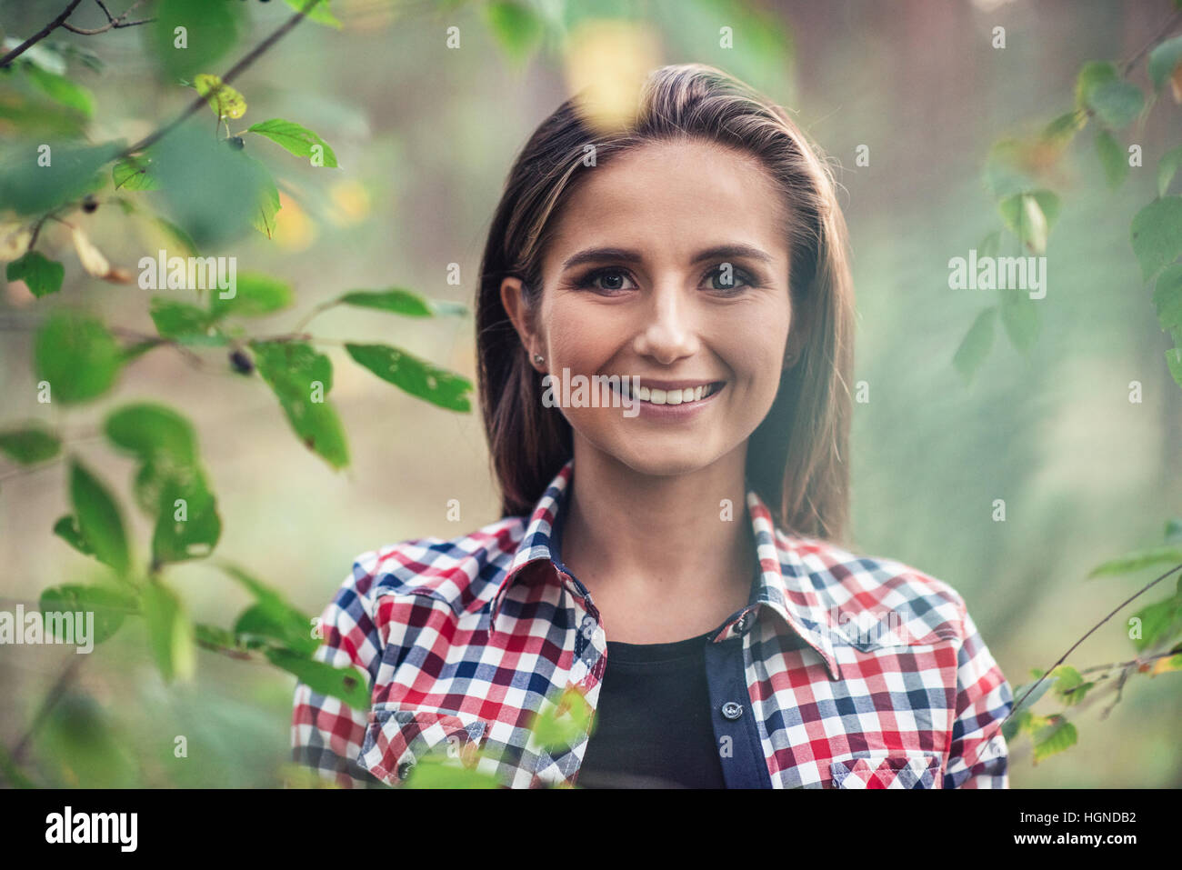 Young woman smiling in nature Stock Photo - Alamy