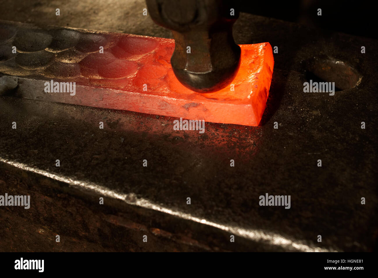 Glowing metal artworks will be completed in the smithy Stock Photo - Alamy