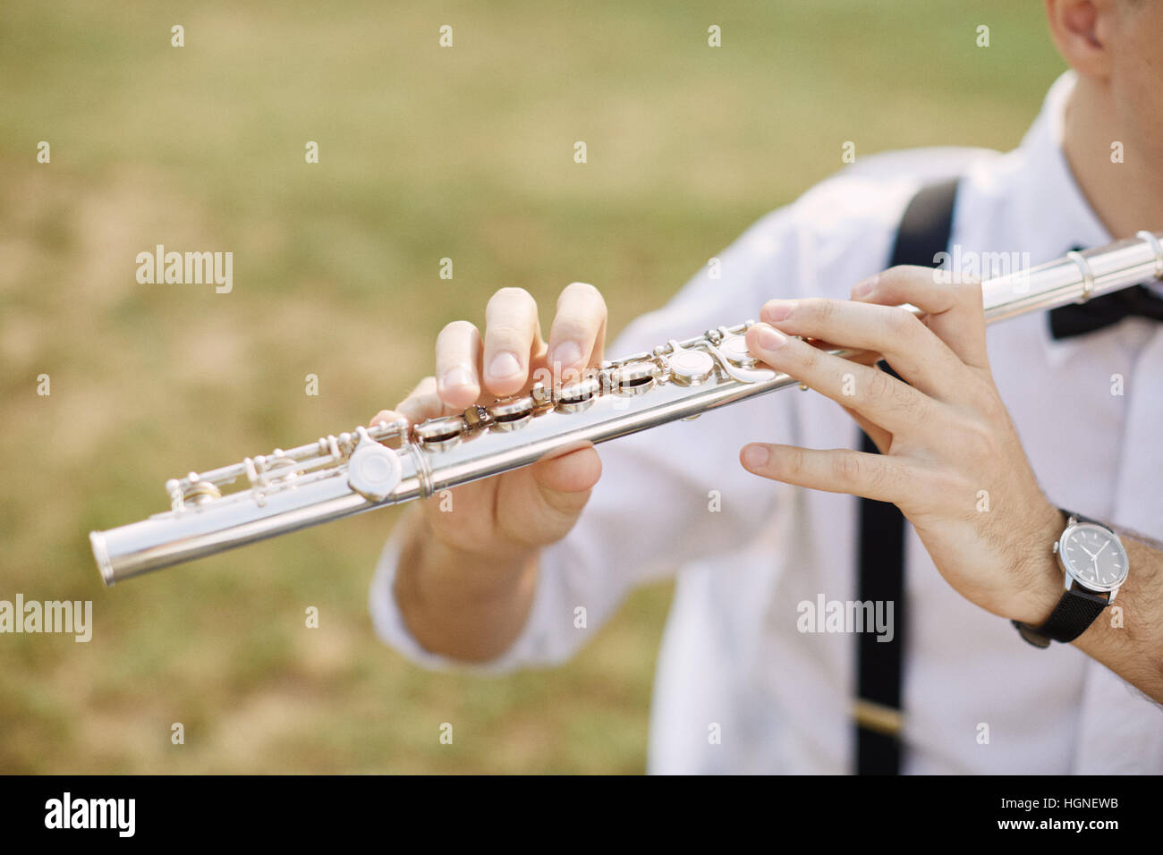 young man playing a clarinet or flute. flutist musician Stock Photo - Alamy