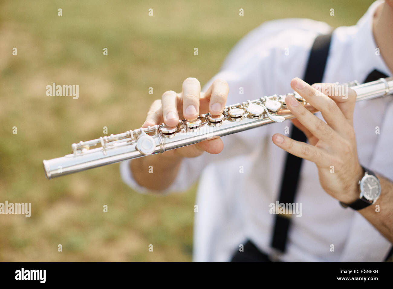 young man playing a clarinet or flute. flutist musician Stock Photo - Alamy