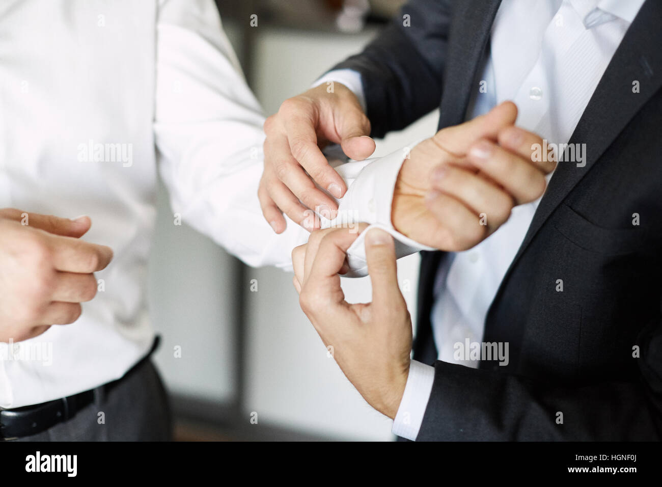 groom getting ready dressed in the morning. buttons in white shirt ...