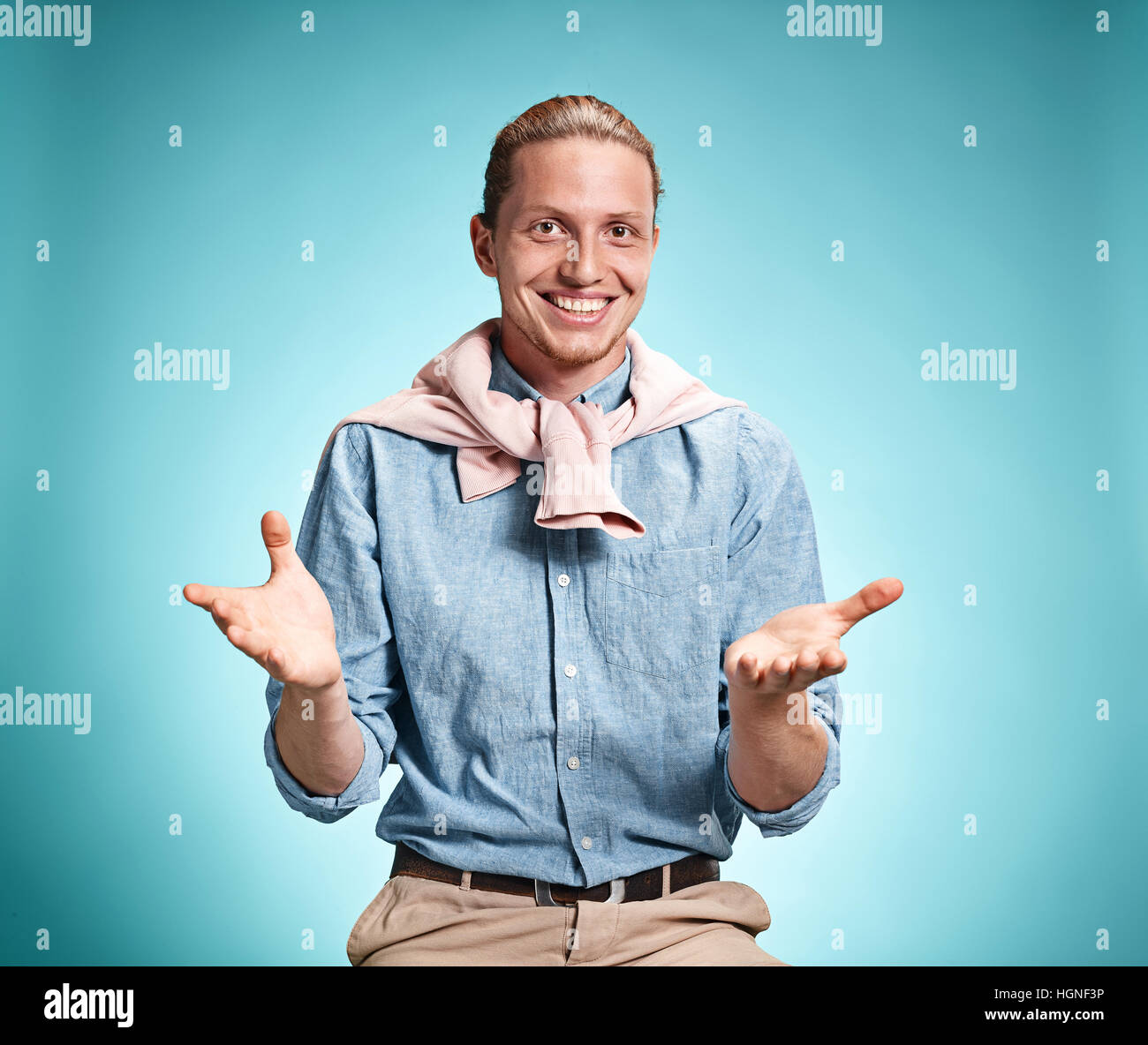Happy excite young man smiling over blue background Stock Photo - Alamy