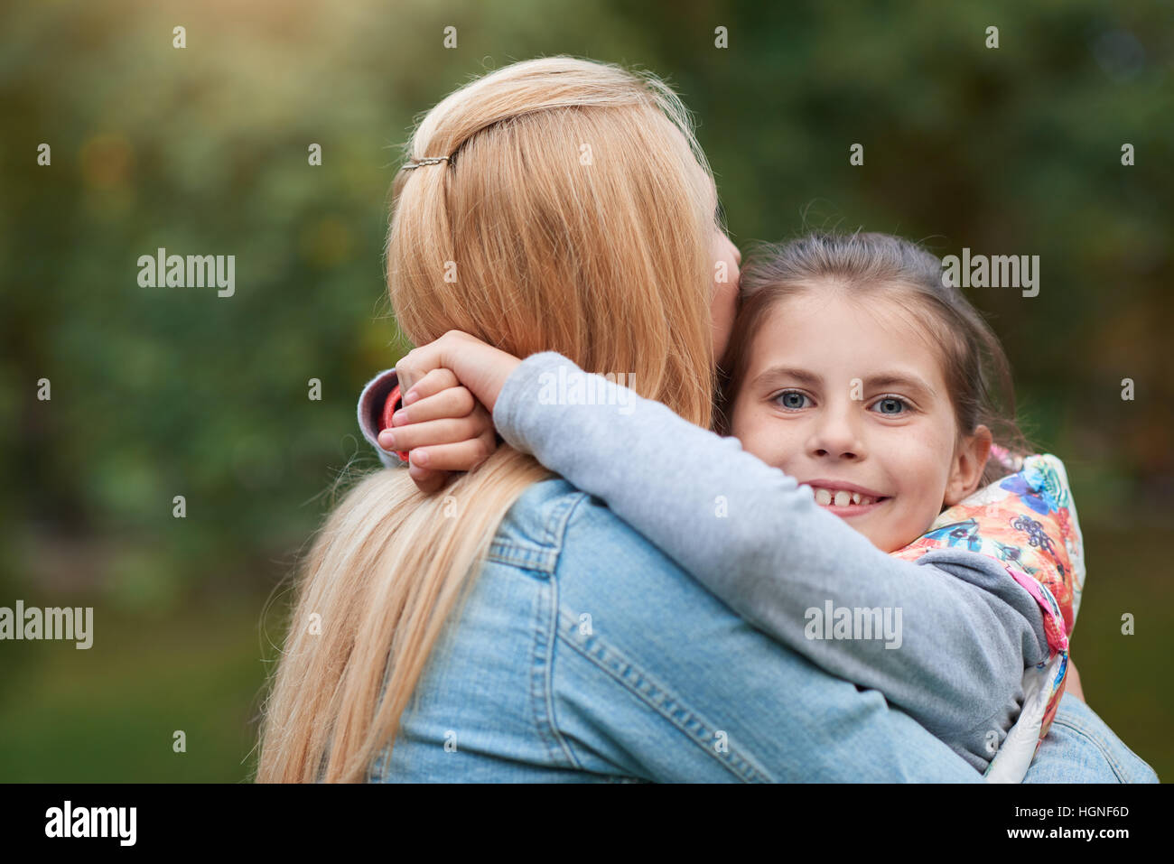 Hugging her mother in the park Stock Photo - Alamy