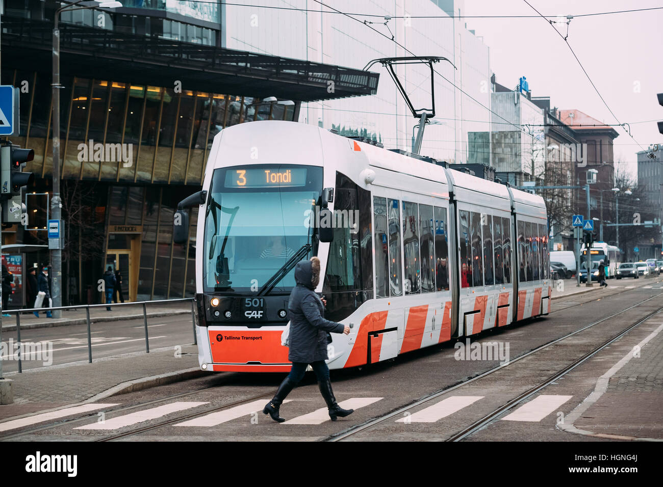 Tallinn, Estonia - December 2, 2016: Woman crossing road at a ...