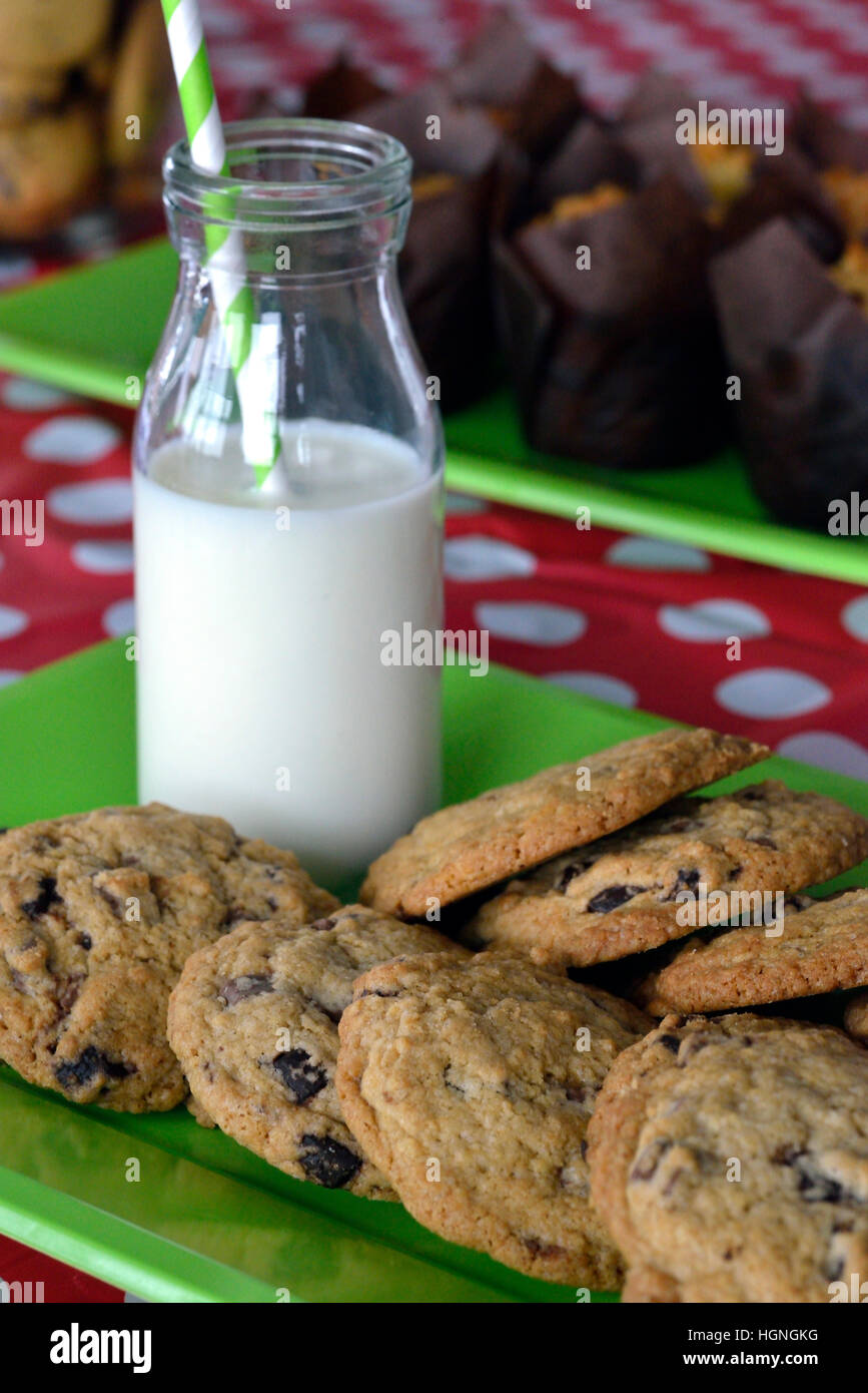 Chocolate chip cookies and bottle of milk with green and white striped ...
