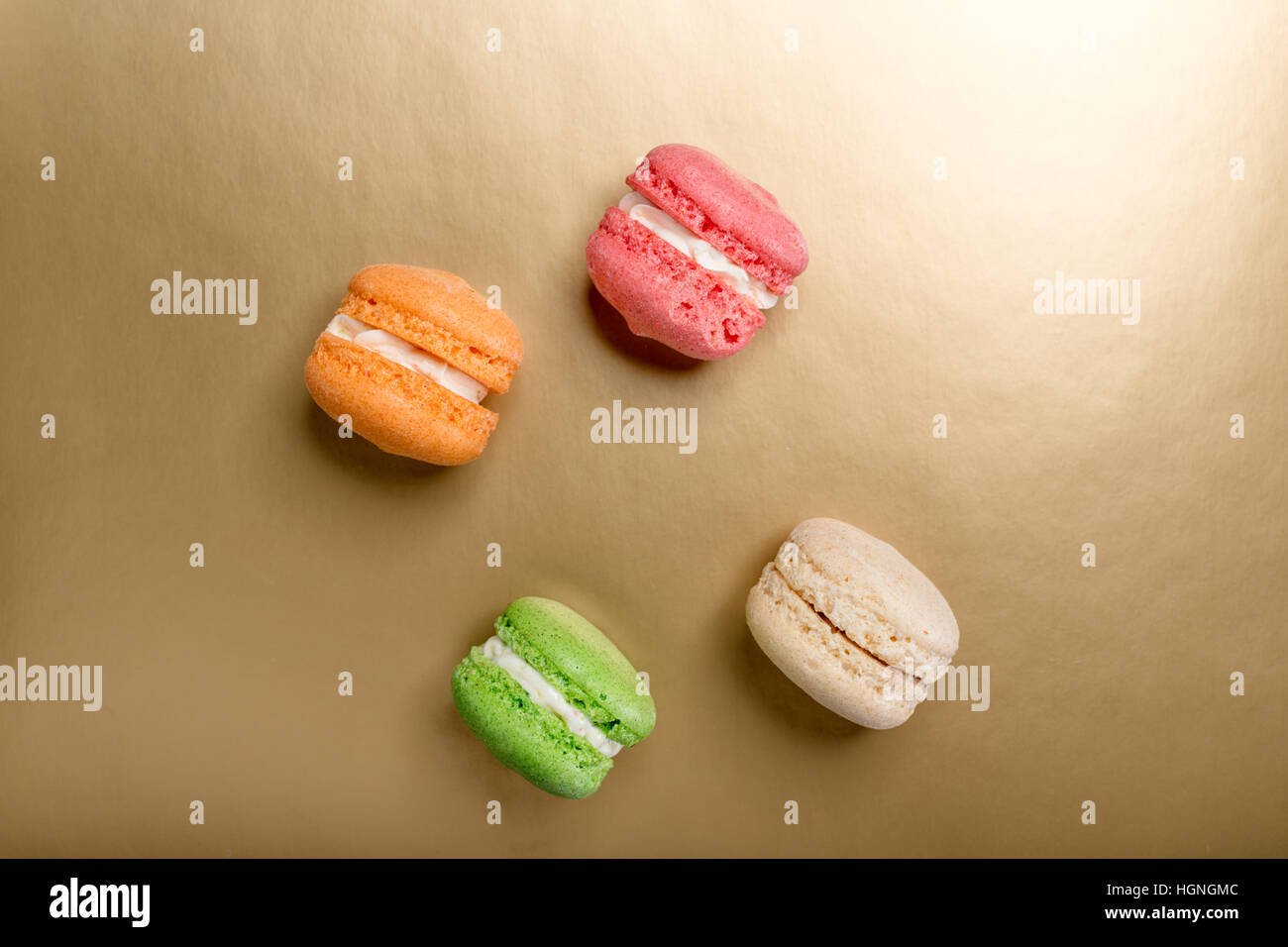 Sweet and colourful macaroons on golden background. Traditional french ...