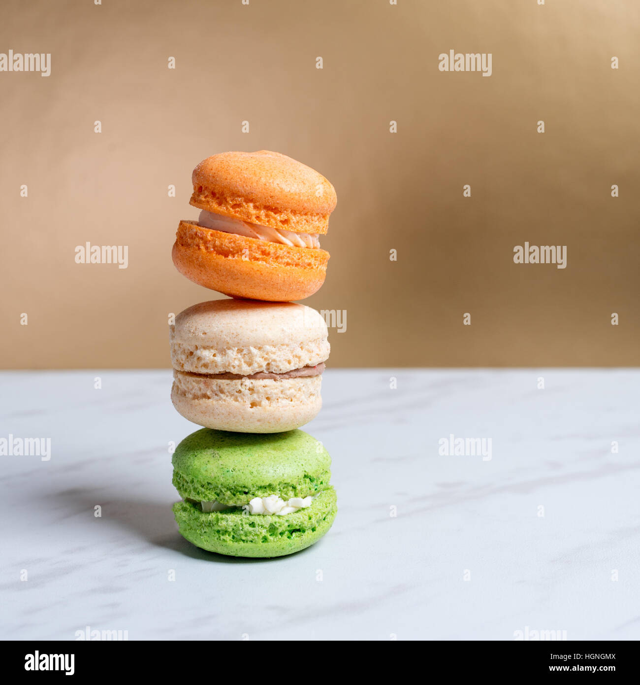 Sweet and colourful macaroons stacked on a marble texture table and ...