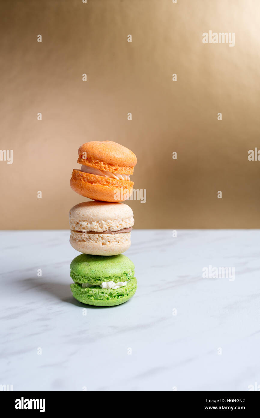 Sweet and colourful macaroons stacked on a marble texture table and ...