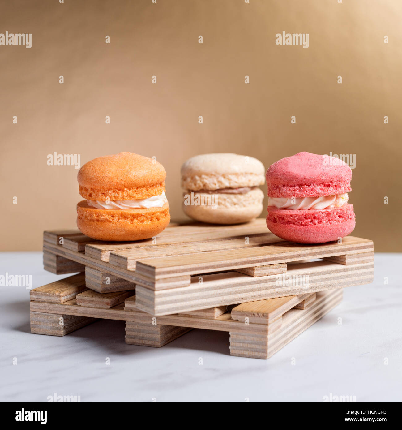 Sweet and colourful macaroons served on little wooden pallets on a ...