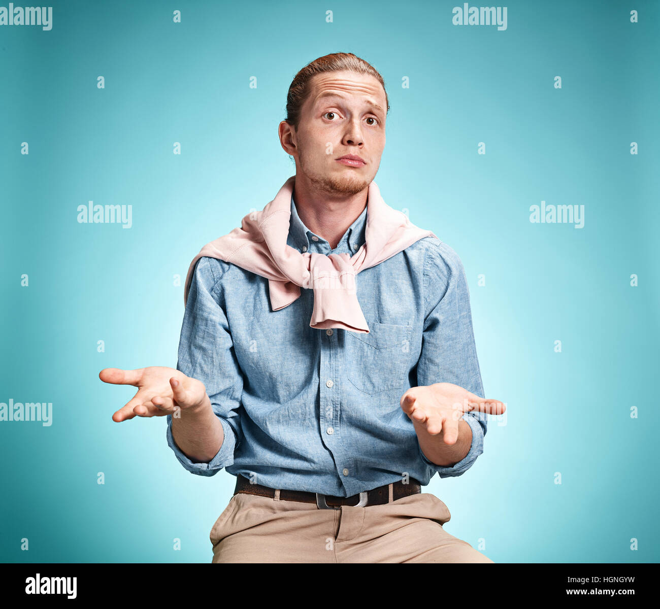 The surprised young man over blue background Stock Photo - Alamy