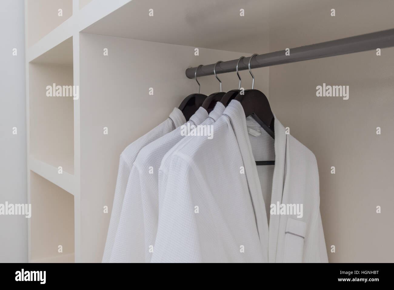 white robes with wooden hangers at dressroom Stock Photo - Alamy