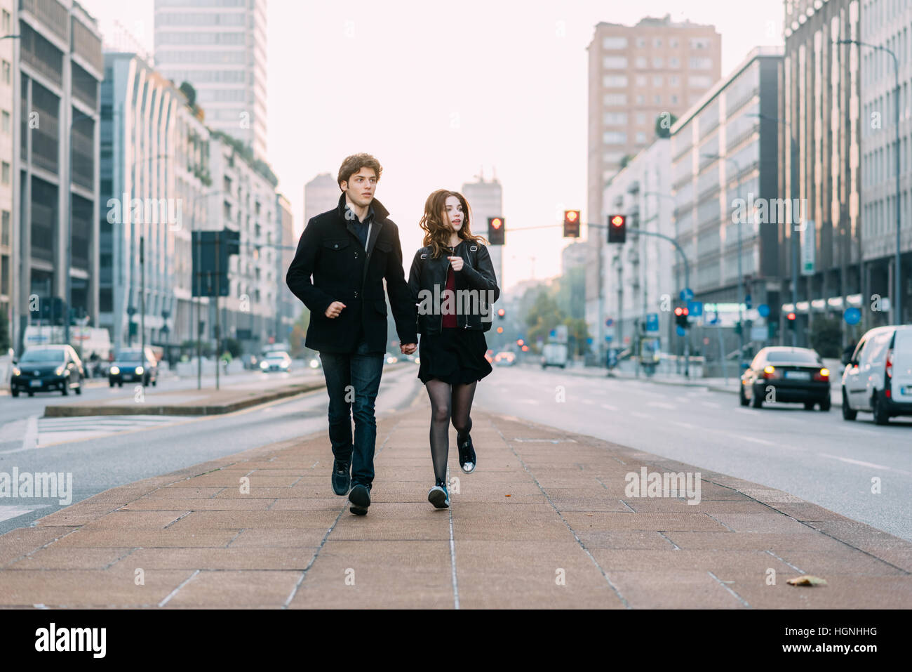 Young beautiful couple in love running outdoor in the city, having fun ...