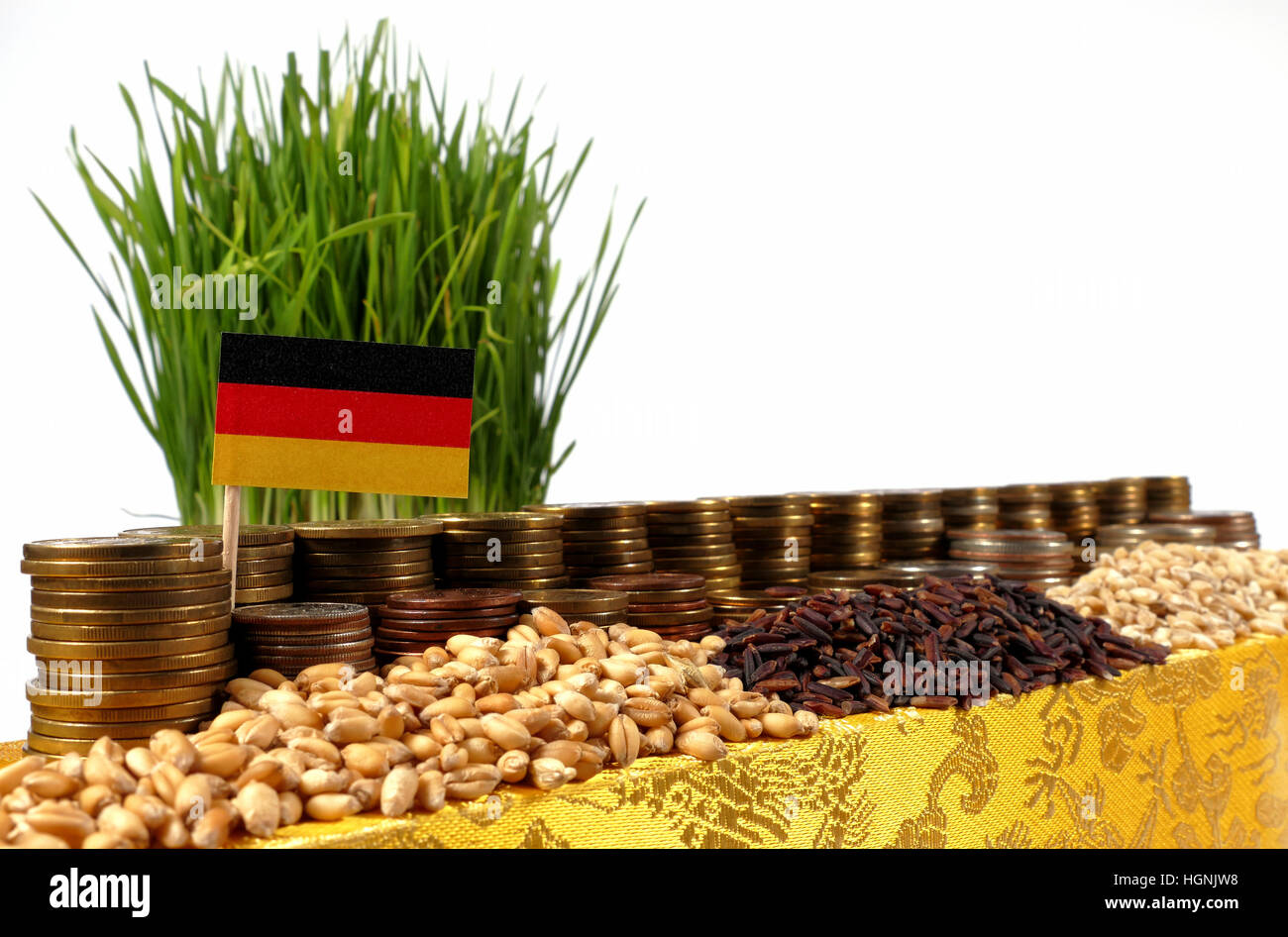 Germany flag waving with stack of money coins and piles of wheat and ...