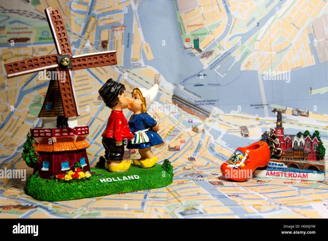 Holland souvenir with Amsterdam maps in background. Dutch windmill with ...