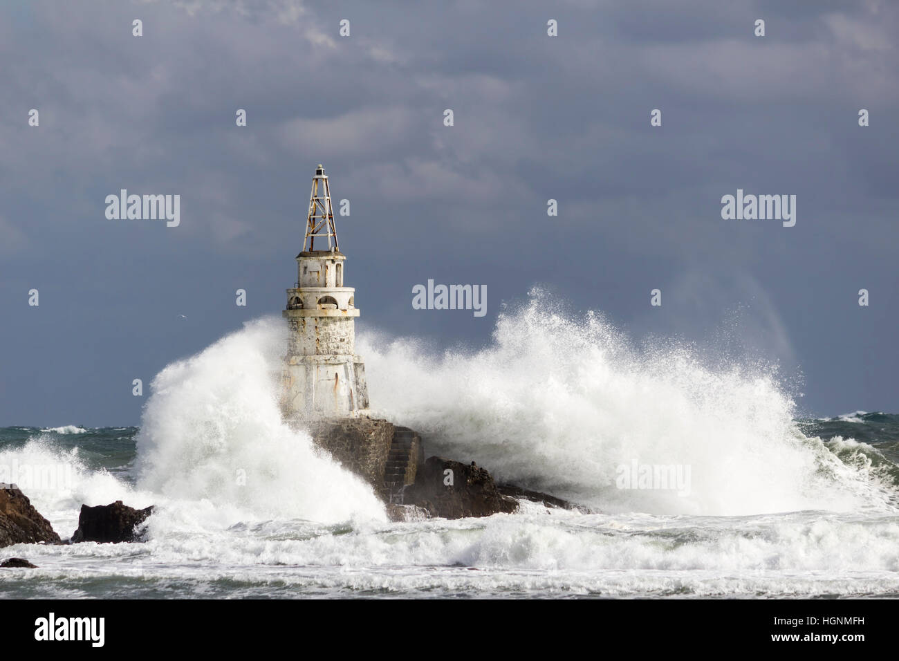 Lighthouse over waves in a stormy sea in the sunlight, Ahtopol ...