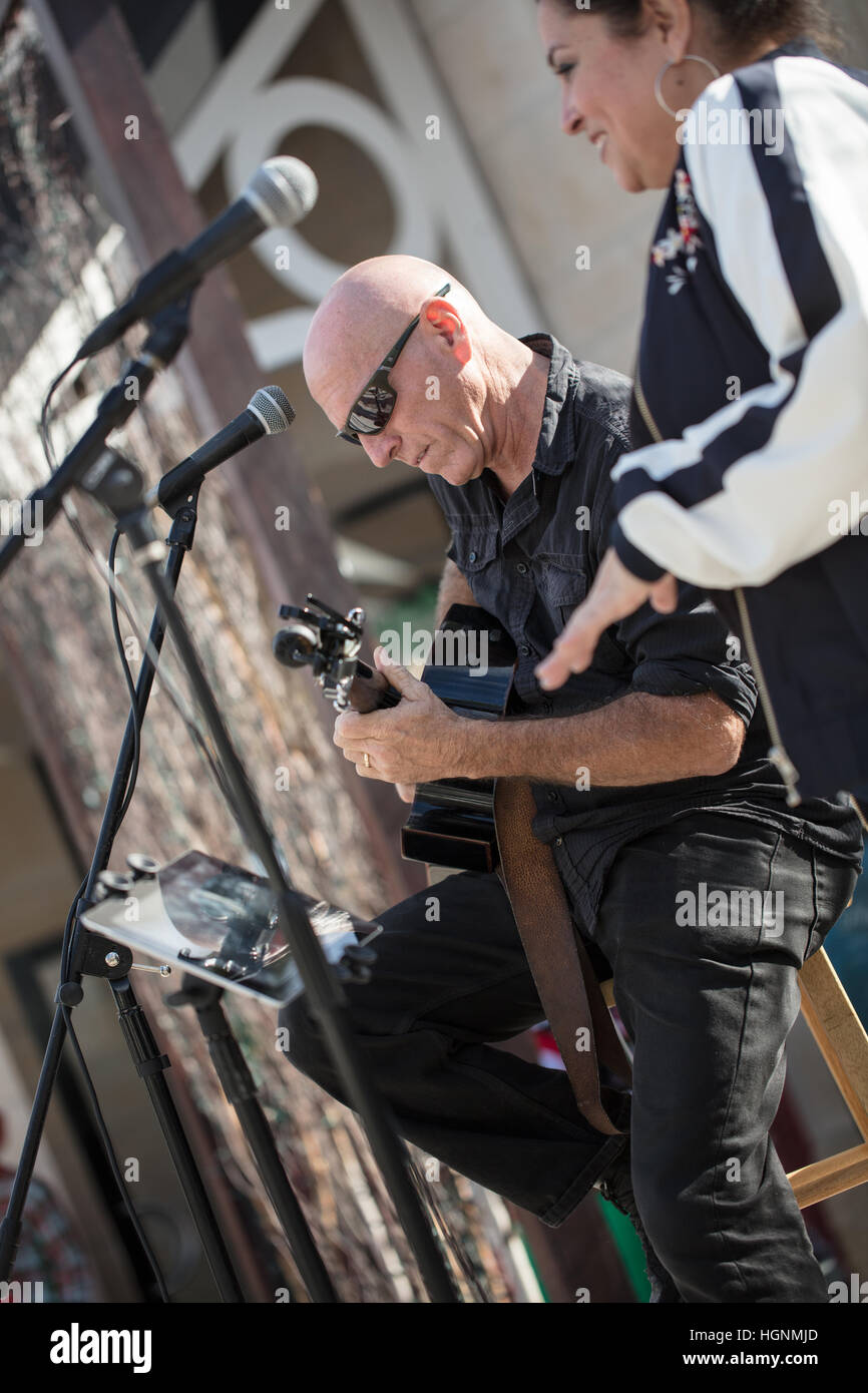 Music Duo singing and playing guitar at an outdoor venue Stock Photo ...