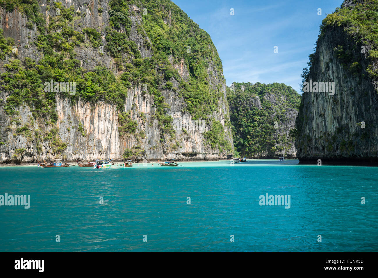 Jungle limestone cliffs around Phi-Phi Leh island with tourist boat ...