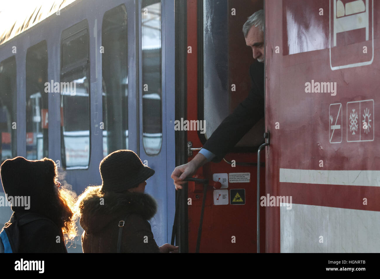 Bucharest, Romania, December 13, 2012: A train controller is helping a ...