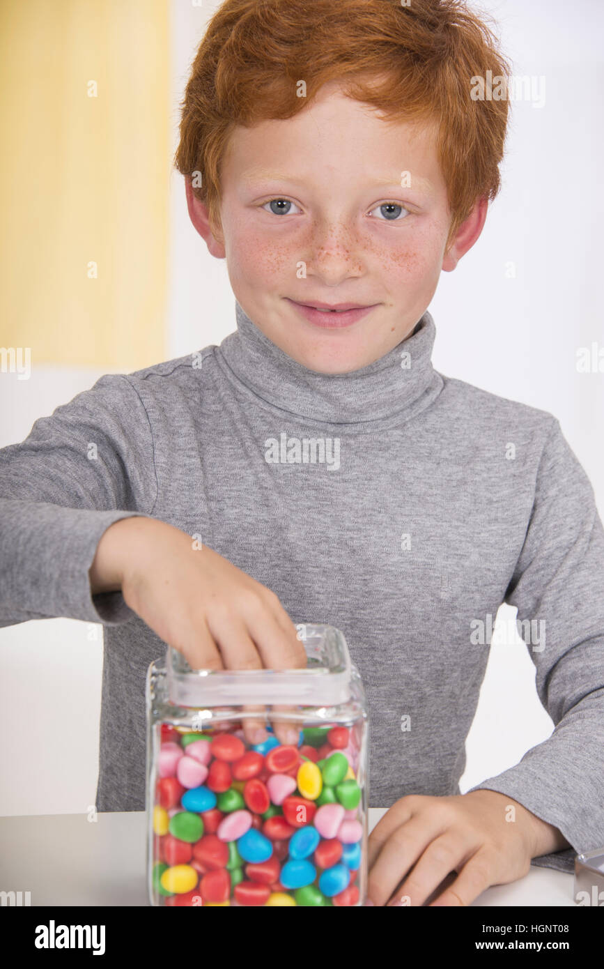 CHILD EATING SWEETS Stock Photo - Alamy